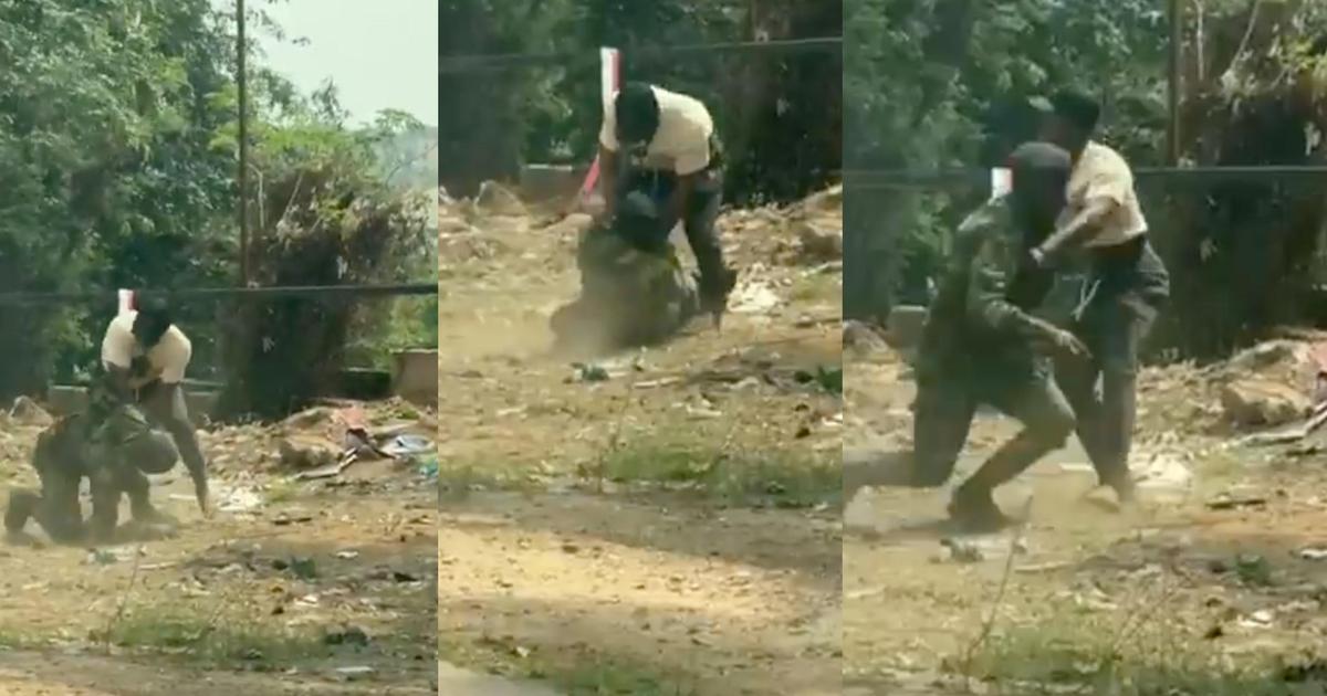 Soldier struggles for freedom as civilian pins him to the ground during ...